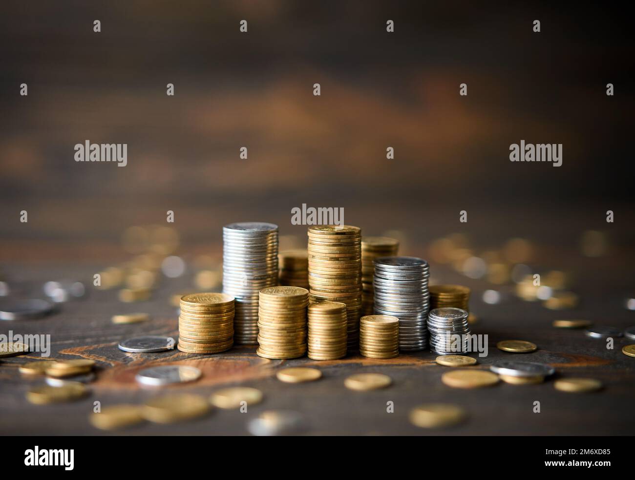 Coins stacks on wooden background Stock Photo - Alamy