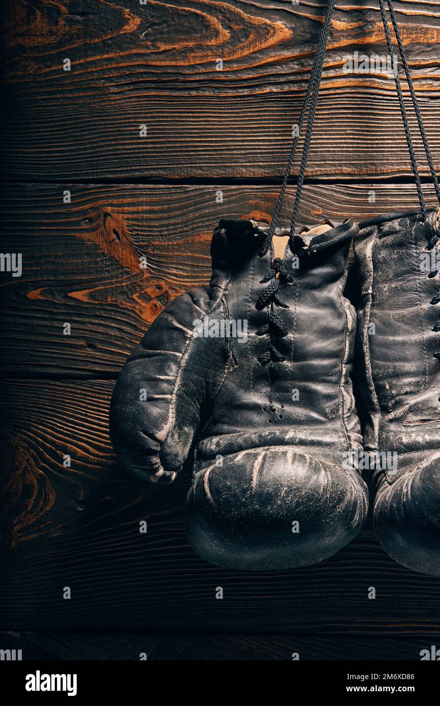 Old boxing gloves hanging on nail on wooden wall Stock Photo - Alamy