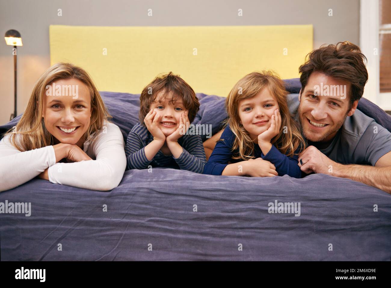 Theyre a close family. Portrait of a young family lying beside each ...