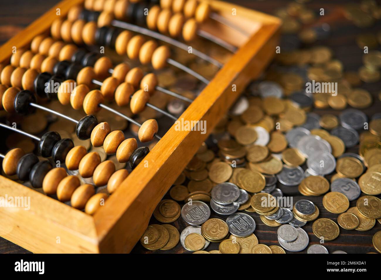 Abacus on coins background Stock Photo - Alamy
