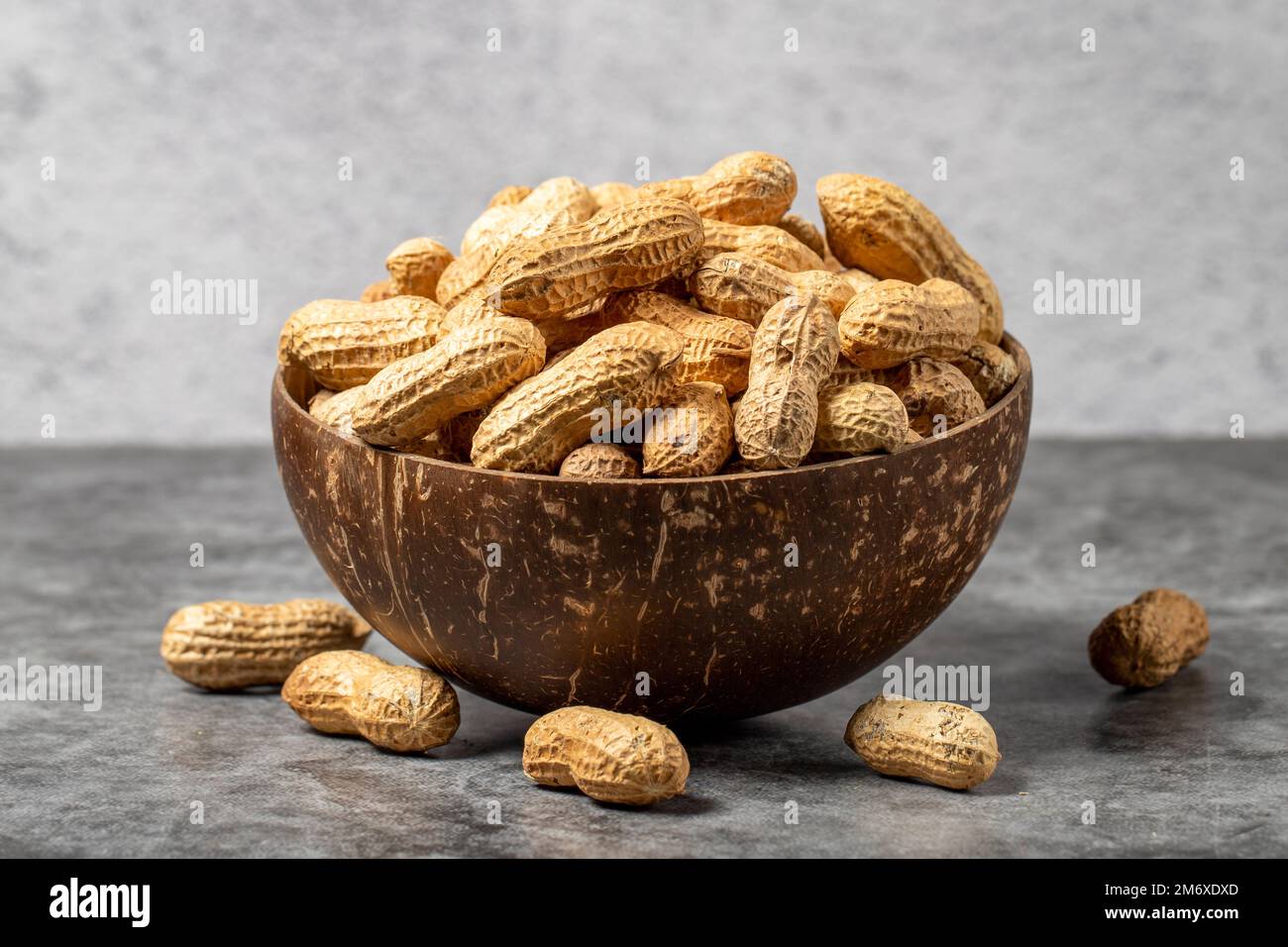 Peanuts in shell on dark background. Peanuts in a coconut bowl. close ...
