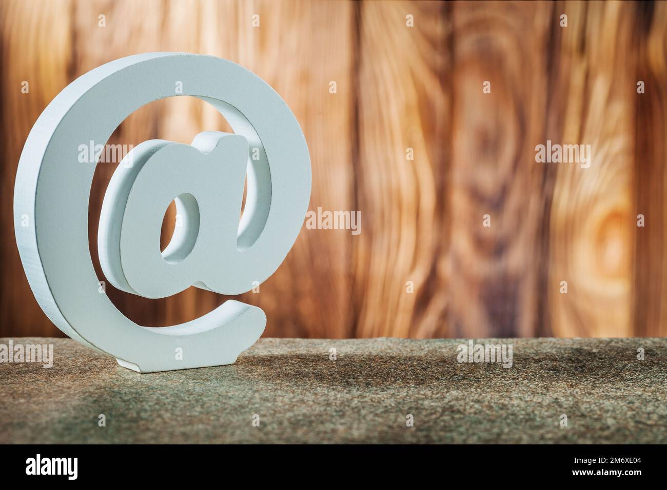 email symbol on sunny vintage wood background Stock Photo - Alamy
