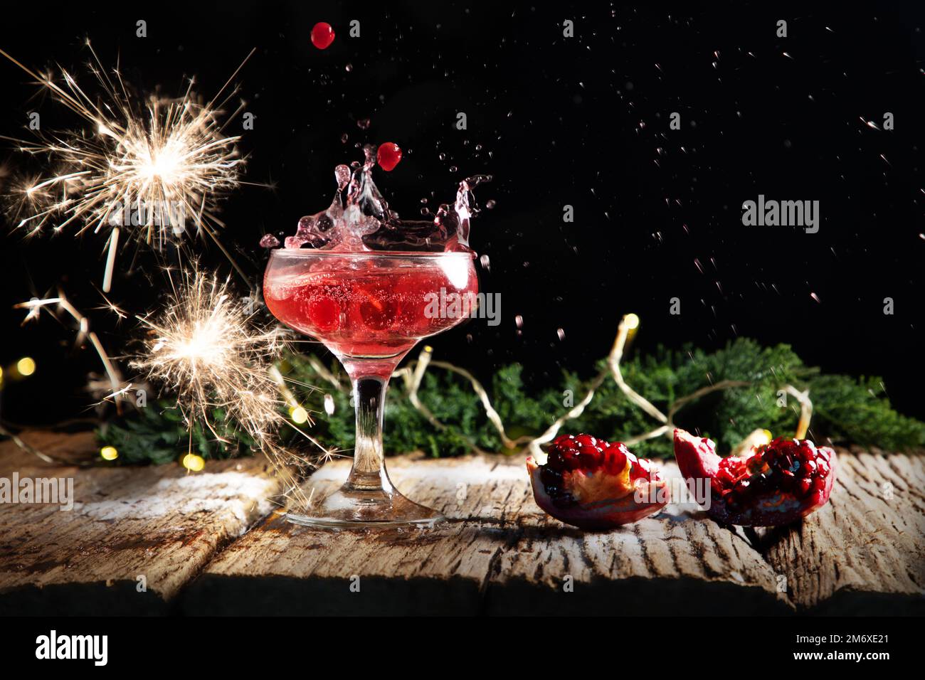 Splashing cocktail and fireworks for New Year Stock Photo - Alamy