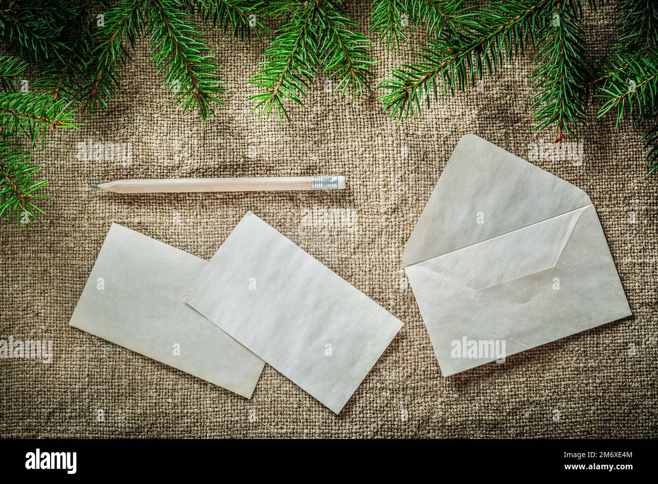 Fir tree twig envelope paper pencil on bagging background Stock Photo ...