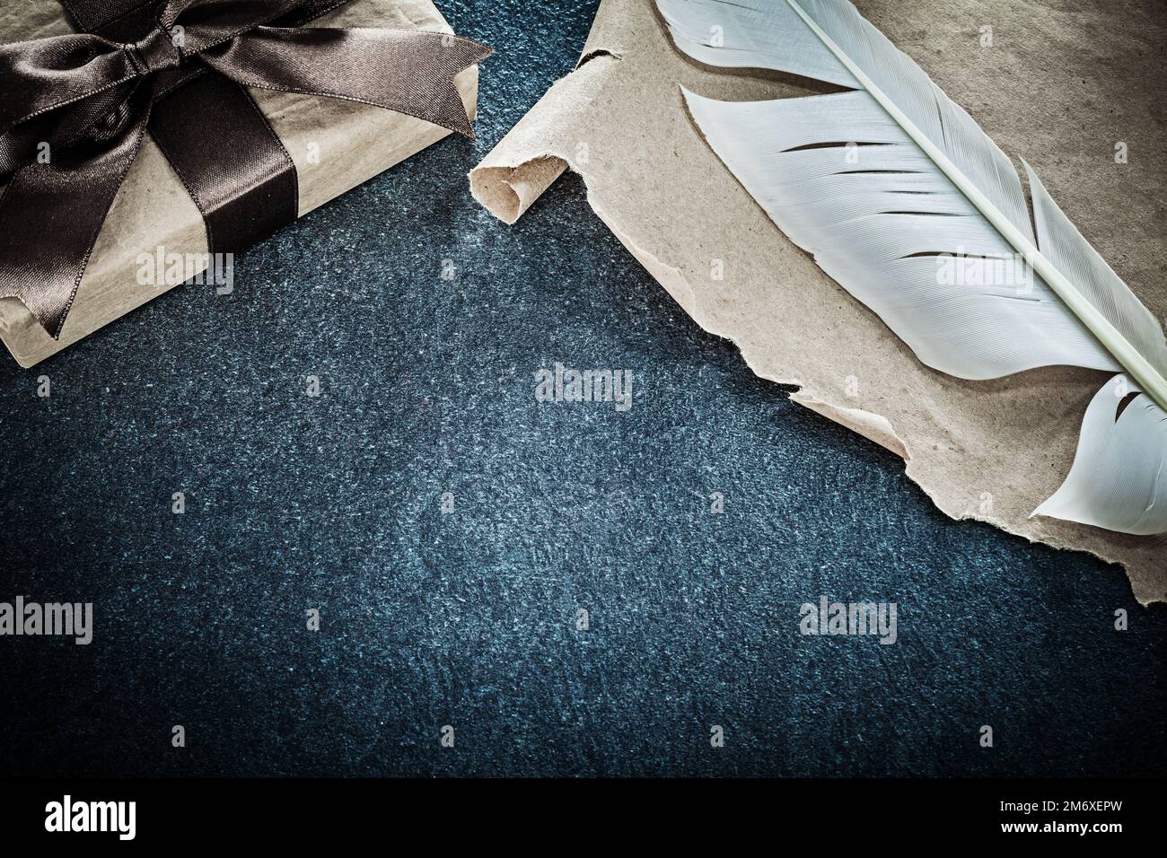 Gift box vintage paper quill on black background Stock Photo - Alamy