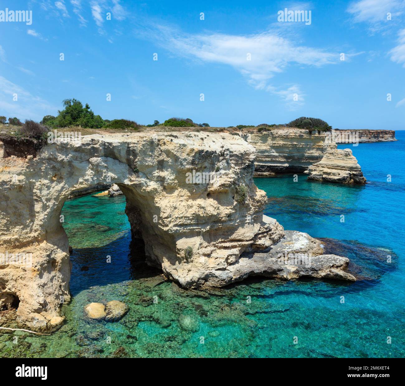 Picturesque seascape with cliffs, rocky arch and stacks (faraglioni ...