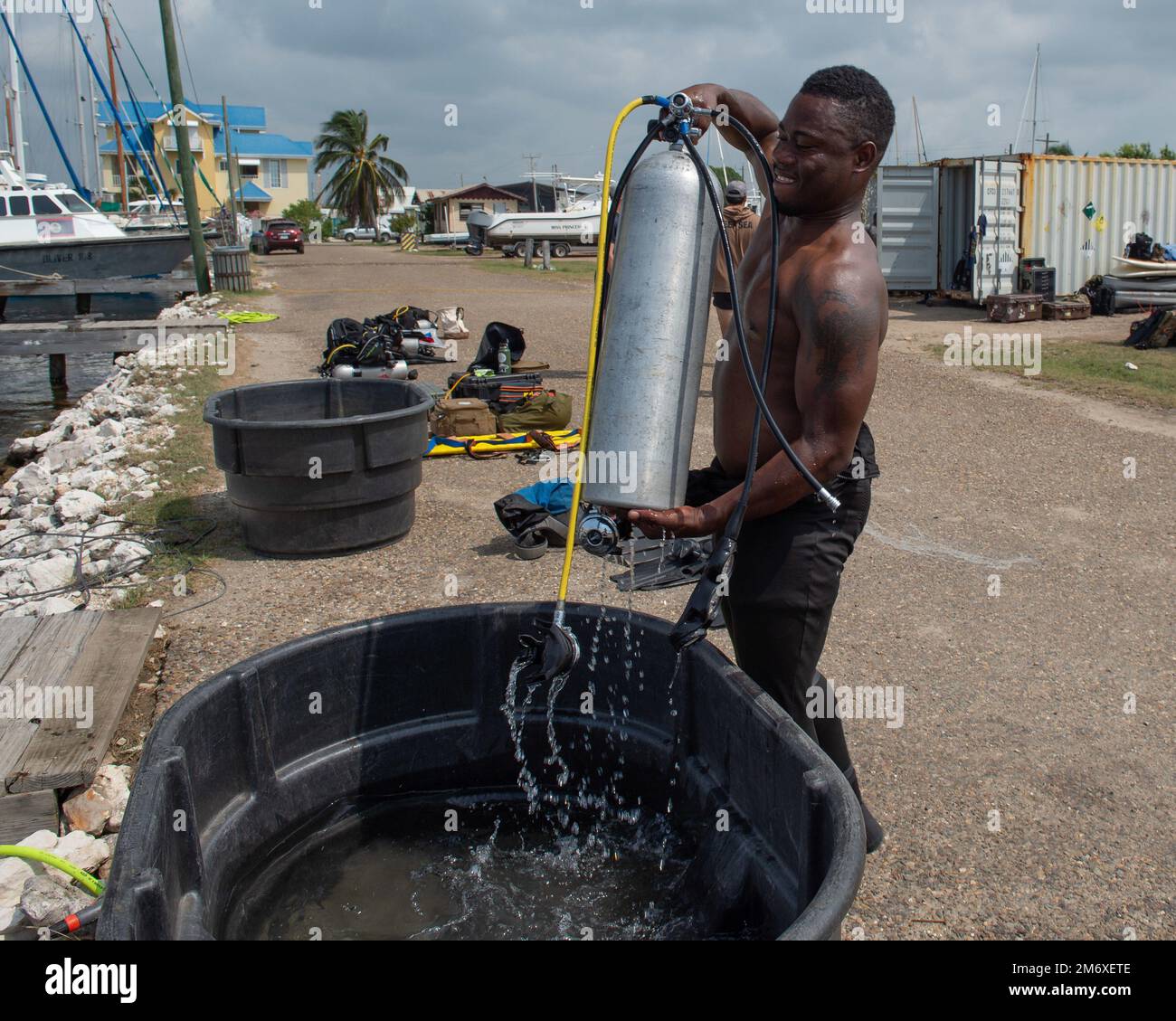 A member of the Caribbean Task Force checks their tanks for leaks before heading into the water ...