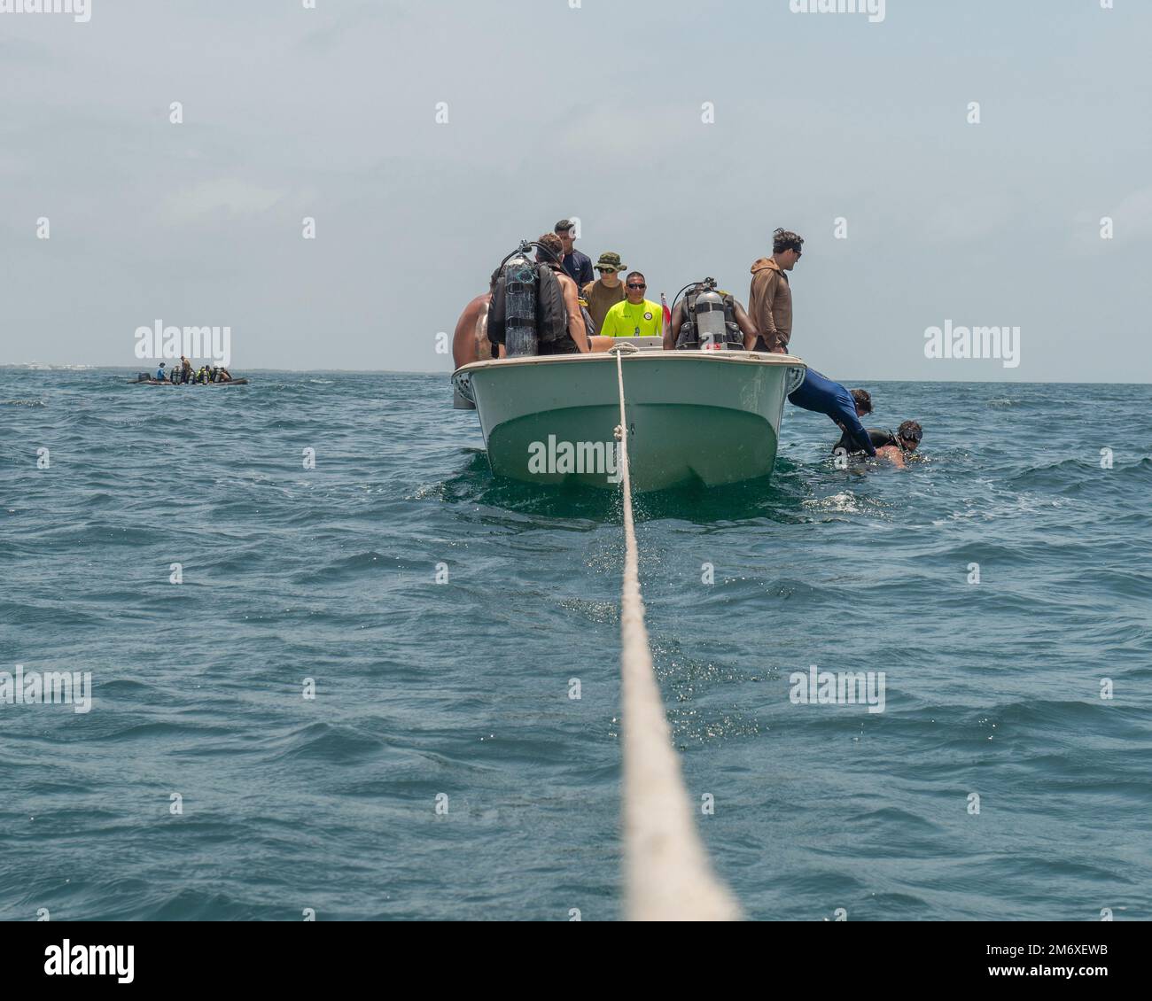 Divers enter the water to begin a familiarization dive during EX ...