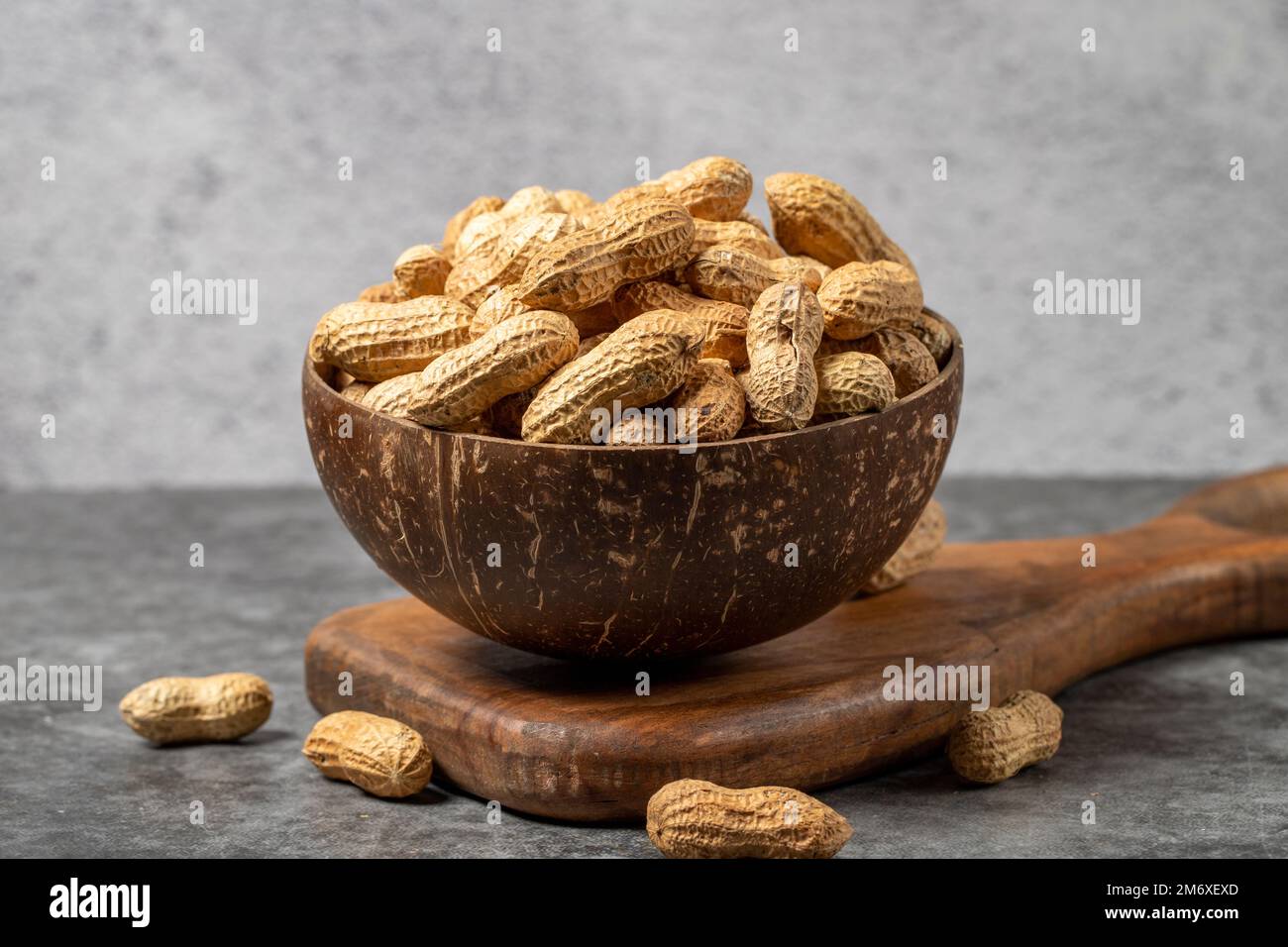 Peanuts in shell on dark background. Peanuts in a coconut bowl. close ...