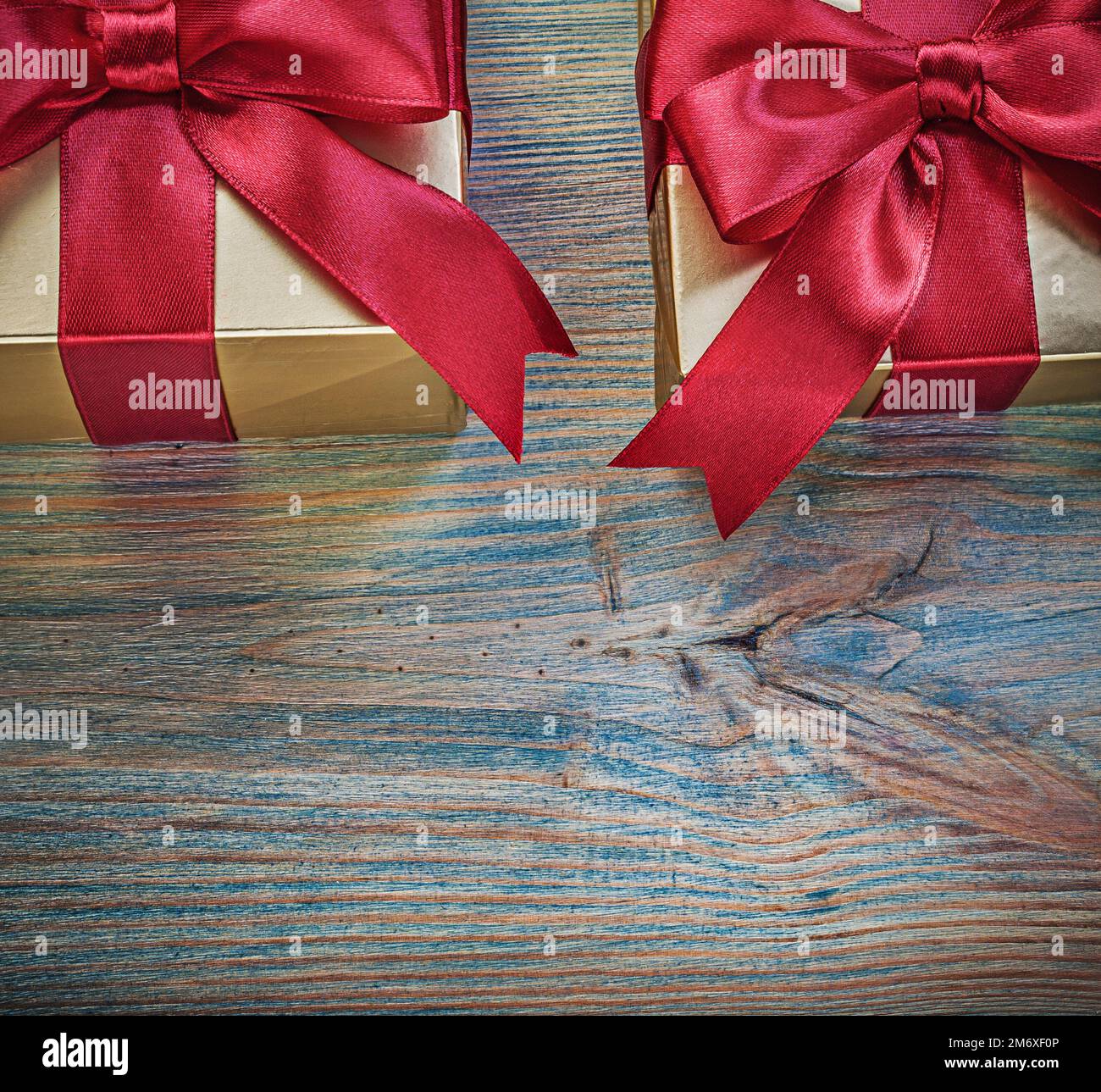 Giftboxes with tied red knots on vintage wood board celebration concept ...