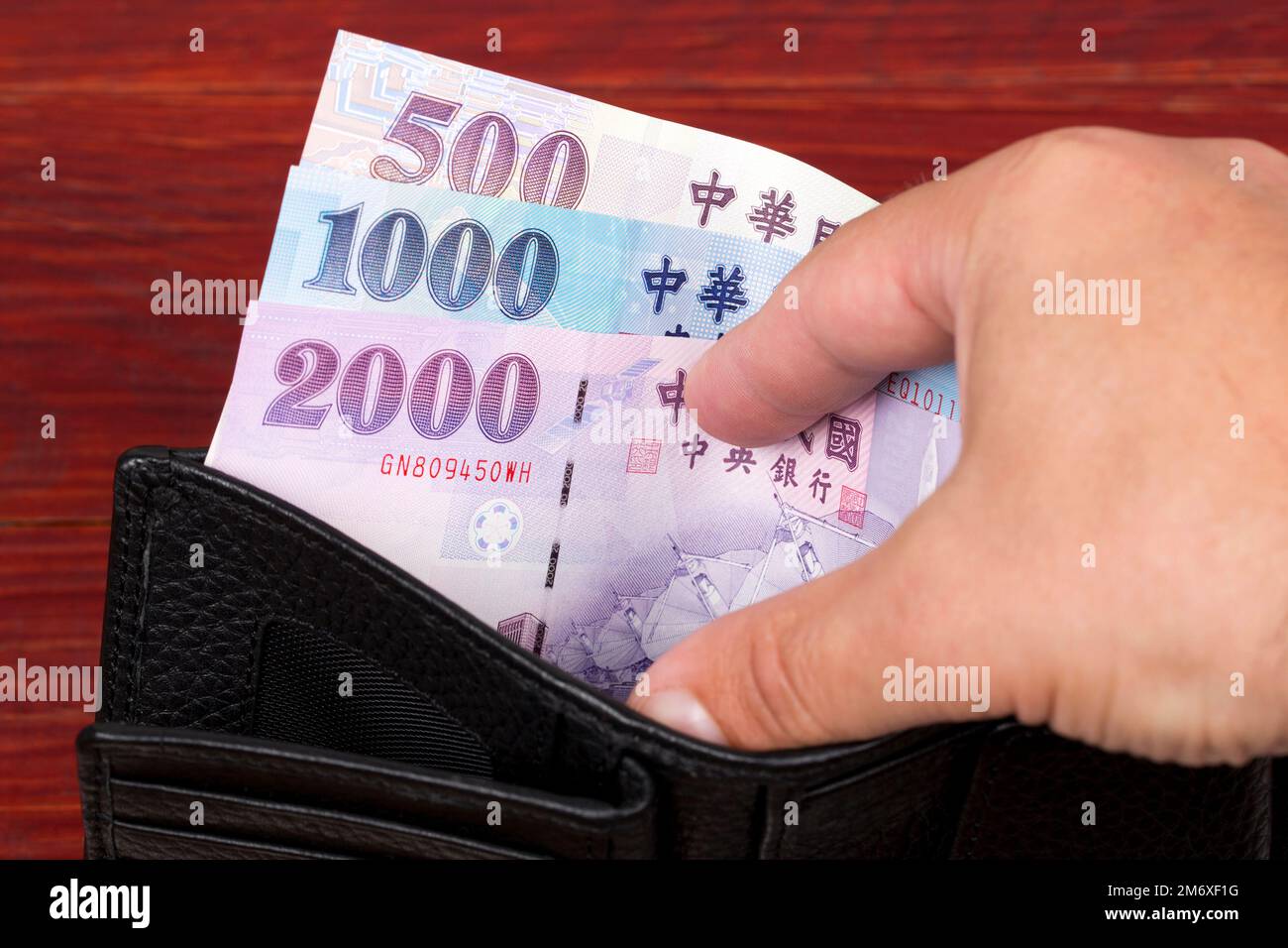 New Taiwan money - dollar in the black wallet Stock Photo - Alamy