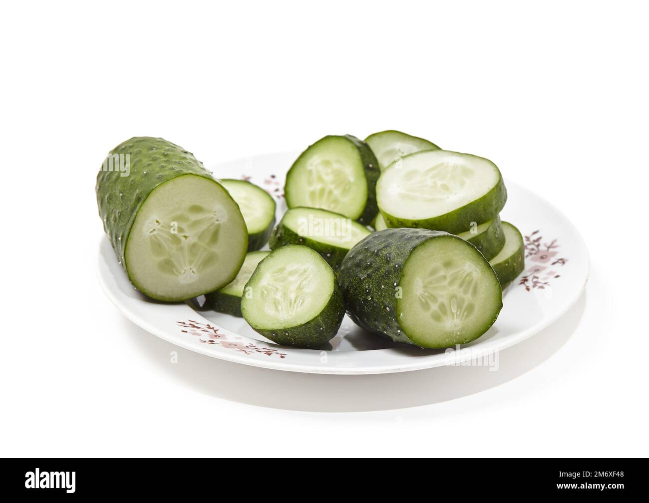 Cucumber and slices on plate isolated over white background. Healthy ...