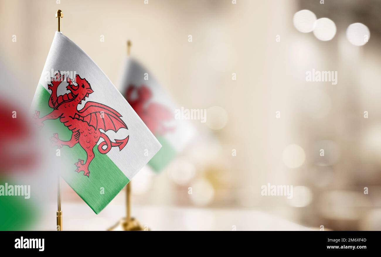 Small flags of the Wales on an abstract blurry background Stock Photo ...
