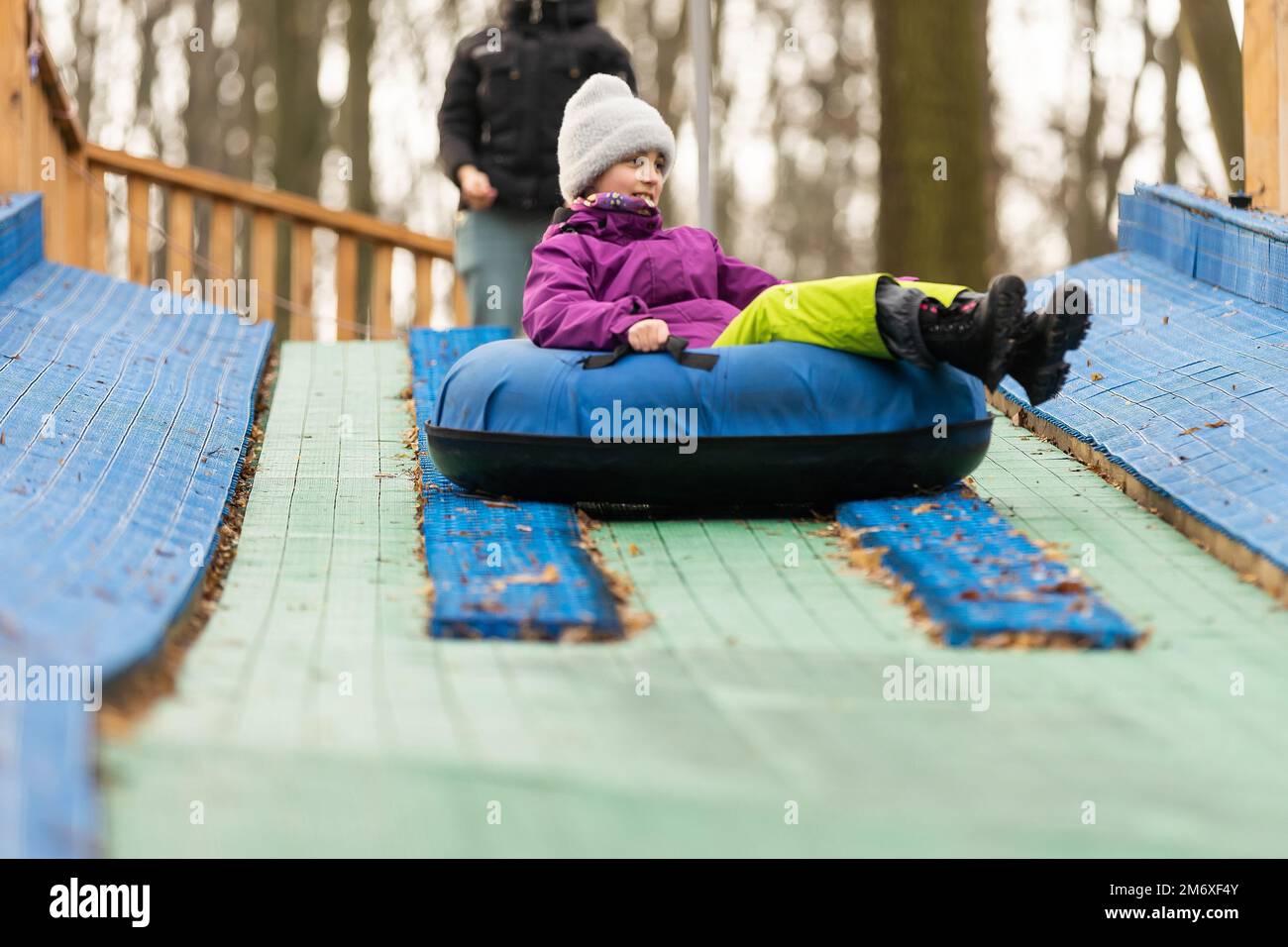 a little kid enjoying tubing down the wavy track ski resort Stock Photo ...