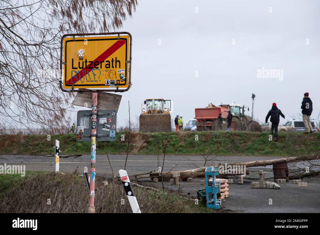 Town limit sign LUETZERATH, in the background construction machinery ...
