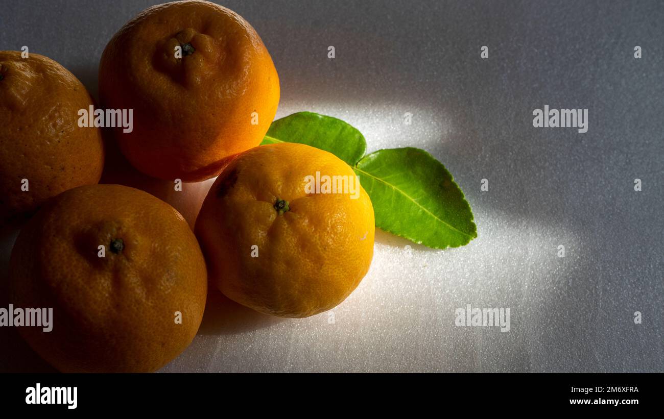 Orange fruits with light and shadow on white background Stock Photo - Alamy