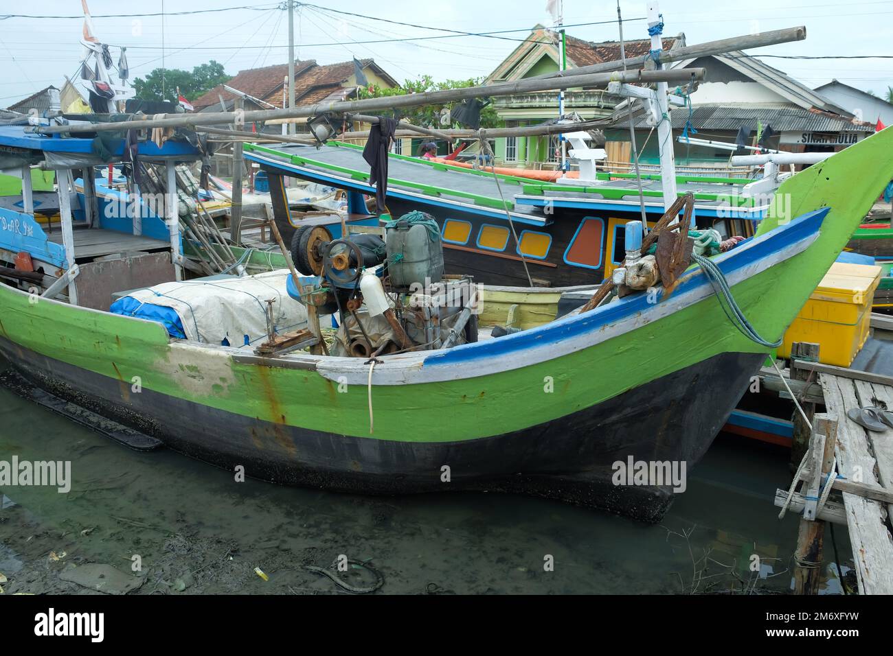 Lampung, Indonesia 9 Nov 2022: A wooden fishing boat ran aground on the pier due to low tide ...
