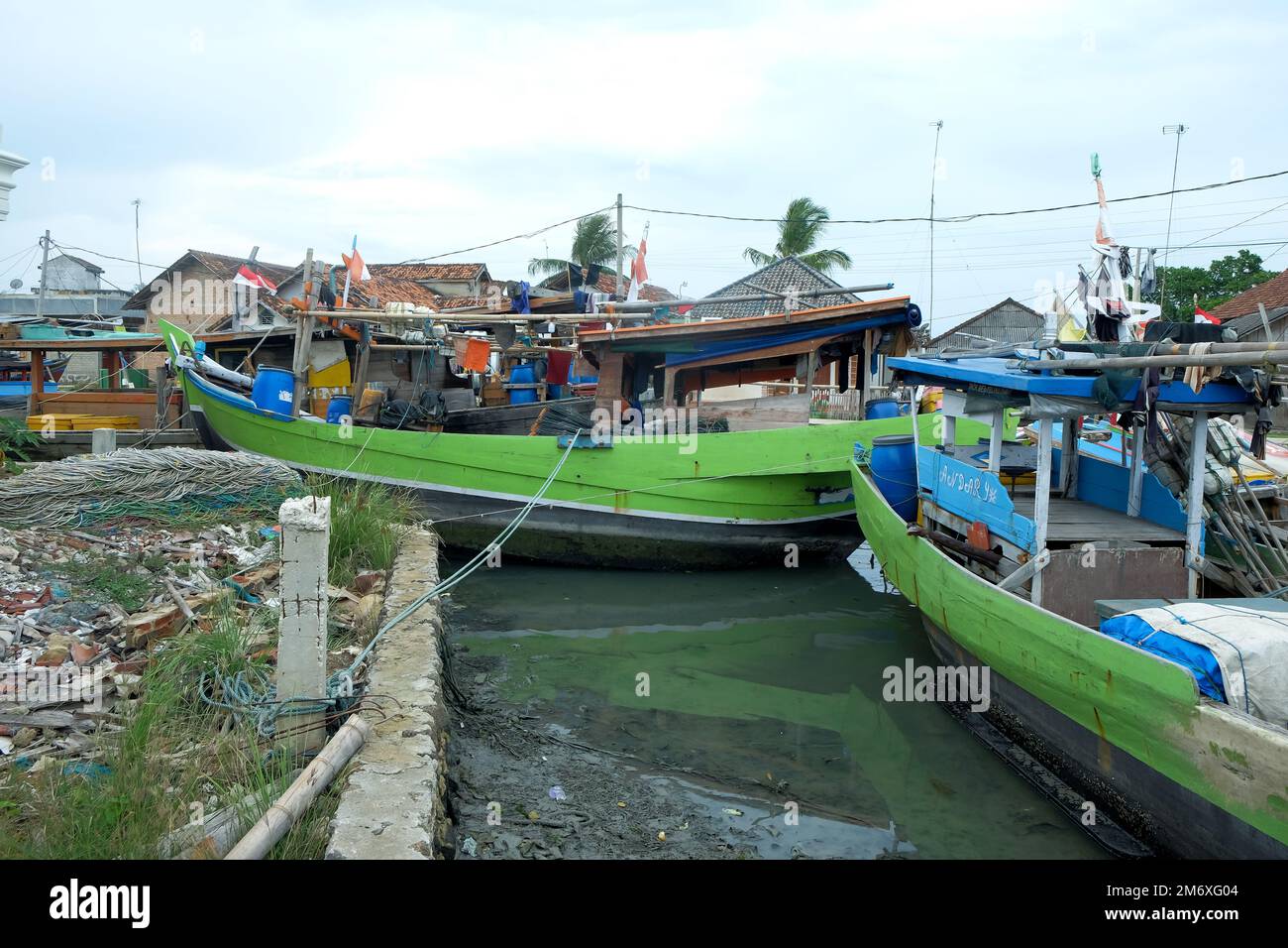 Lampung, Indonesia 9 Nov 2022: A wooden fishing boat ran aground on the pier due to low tide ...