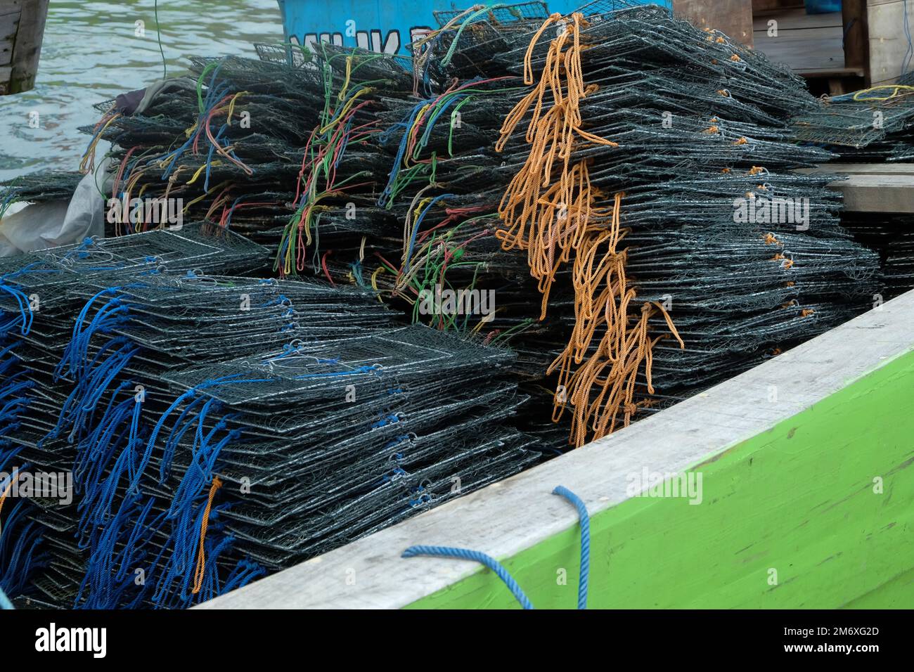 Stack of folding nets for catching crabs on the bow of a fishing boat ...