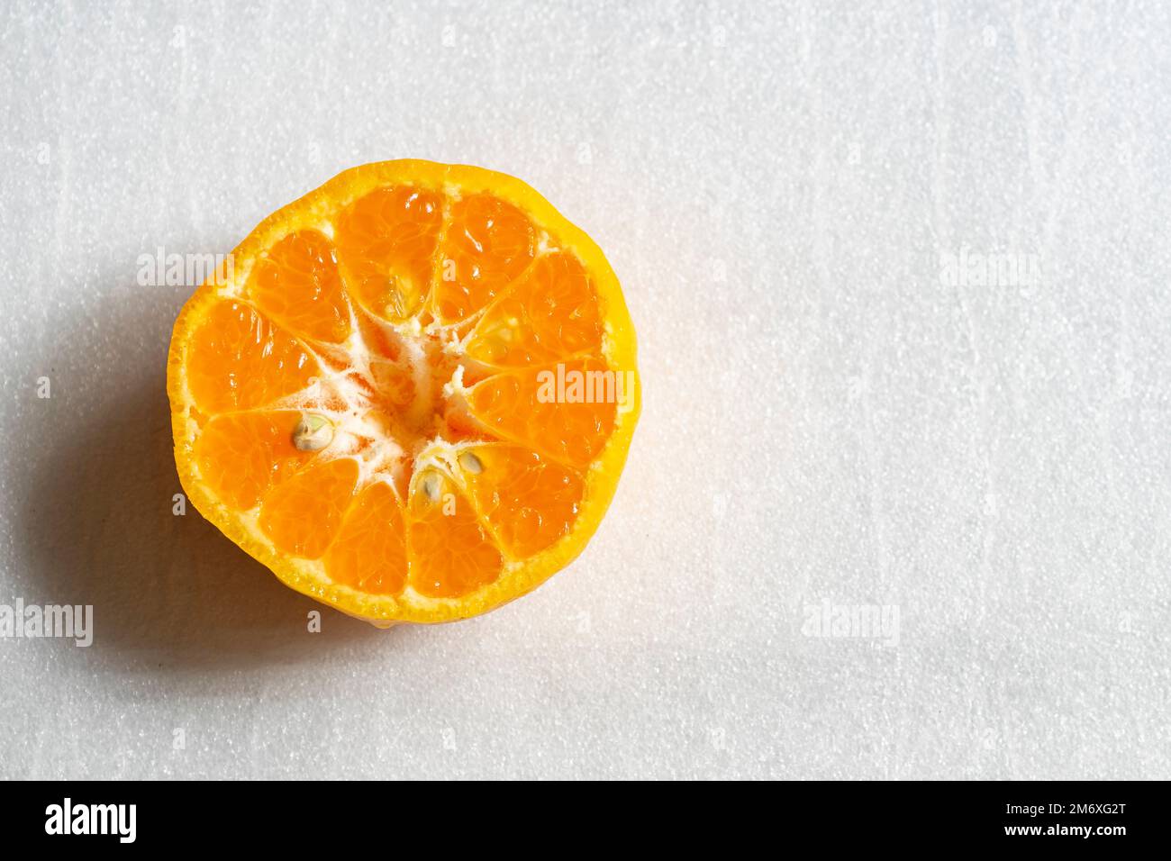 Orange with cut in half and green leaves isolated on white background ...