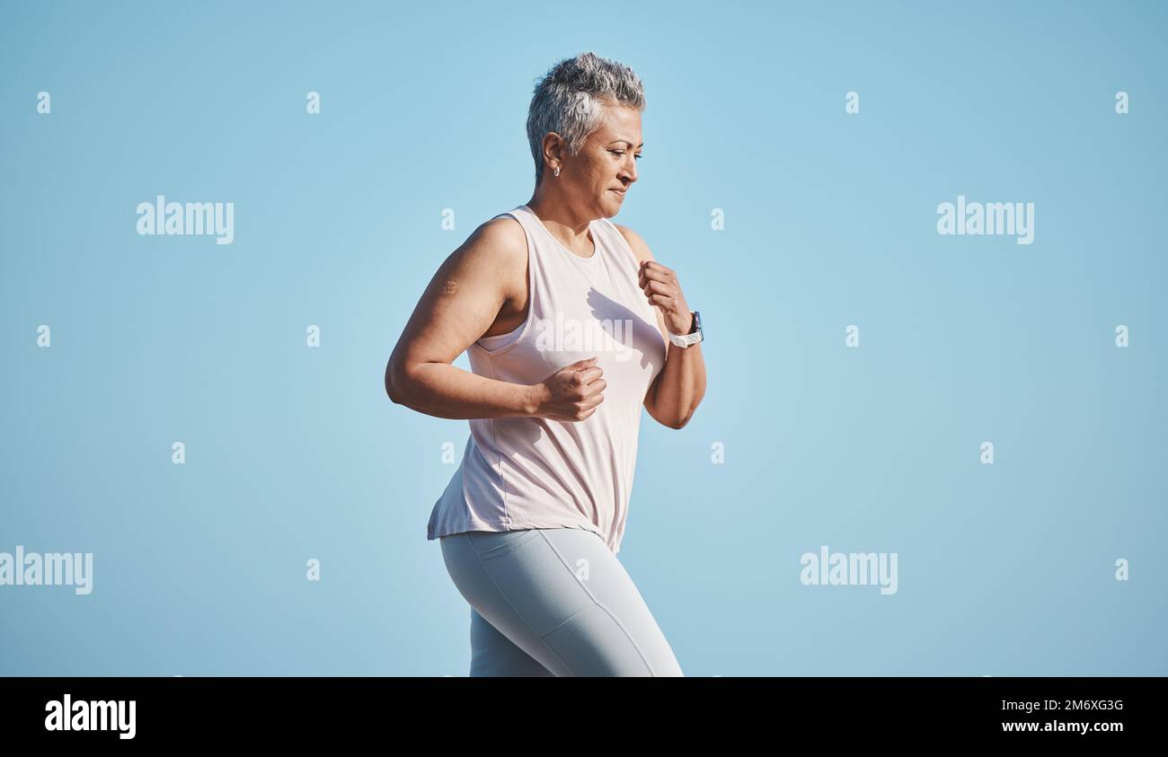 Fitness, nature and senior woman running for health, wellness and ...