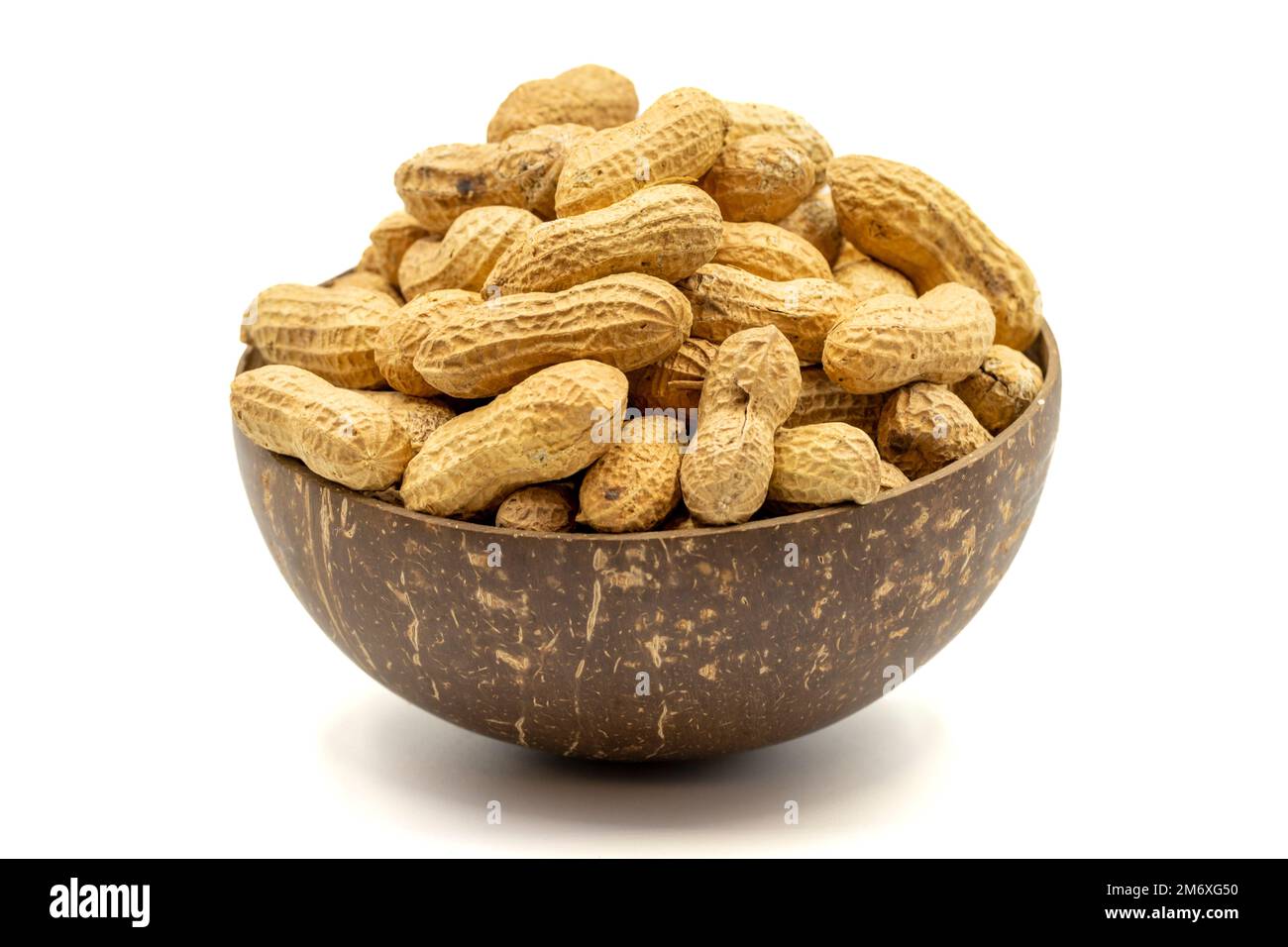 Peanuts in shell isolated on white background. Peanuts in a coconut ...