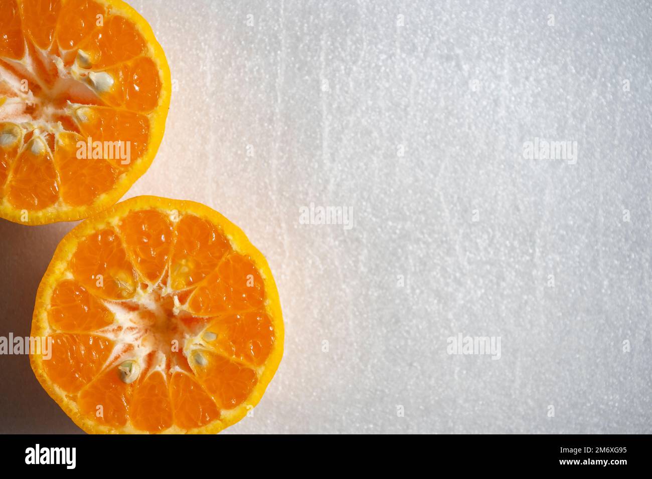Orange with cut in half and green leaves isolated on white background ...