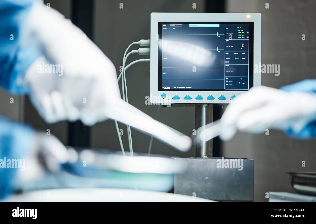 Electrocardiogram monitor, hands of doctors with scalpel for surgery ...