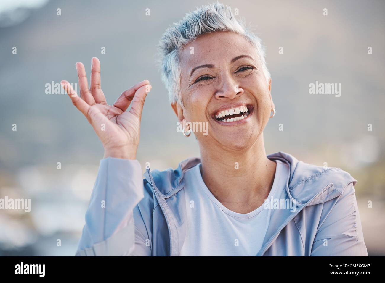 OK hand, fitness senior woman and nature portrait for exercise ...