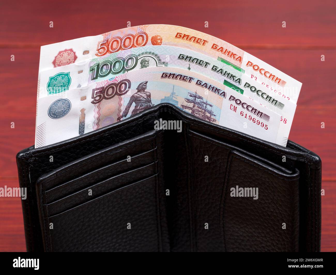 Russian ruble in the black wallet Stock Photo - Alamy