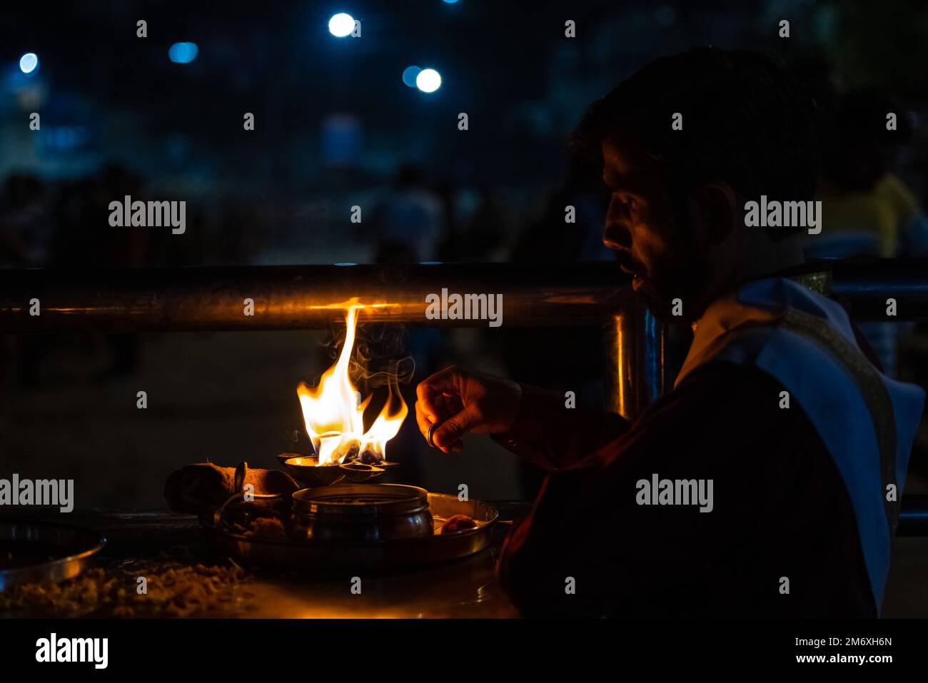 Fire flame at night with dark background during the ganga aarti rituals ...