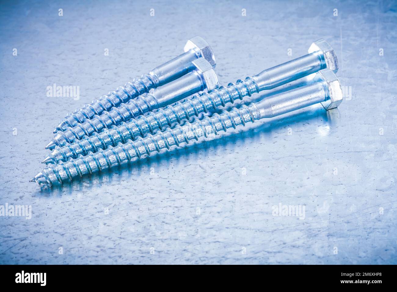 Composition of threaded metal screw bolts on metallic background ...
