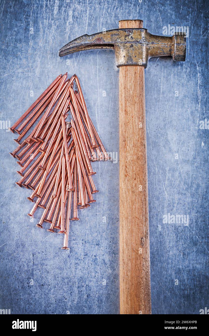 Composition of vintage claw hammer copper construction nails on ...