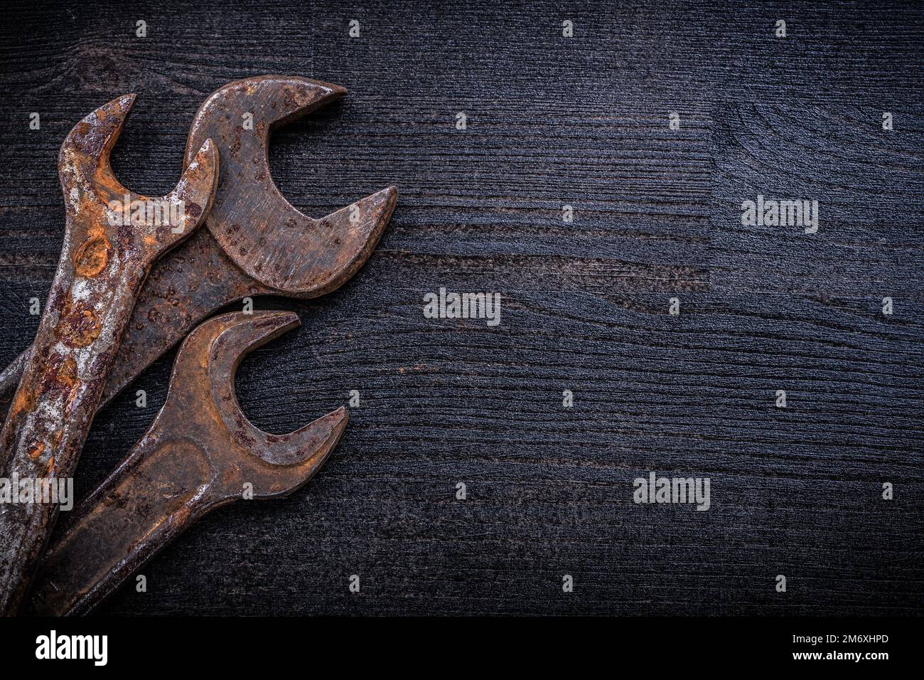 Composition of vintage spanner wrenches on wood board construction ...
