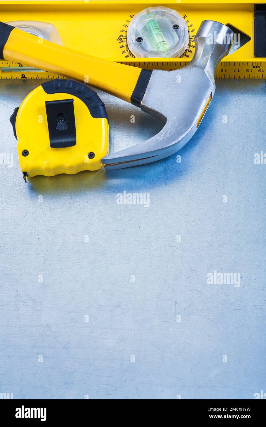 Construction level tape line claw hammer on metallic background ...