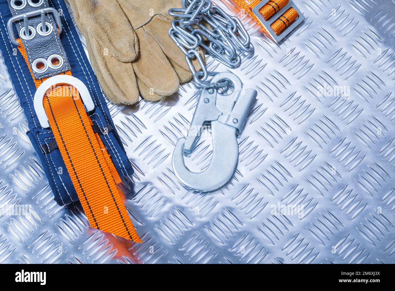 Construction safety harness with gloves on corrugated metall sheet ...