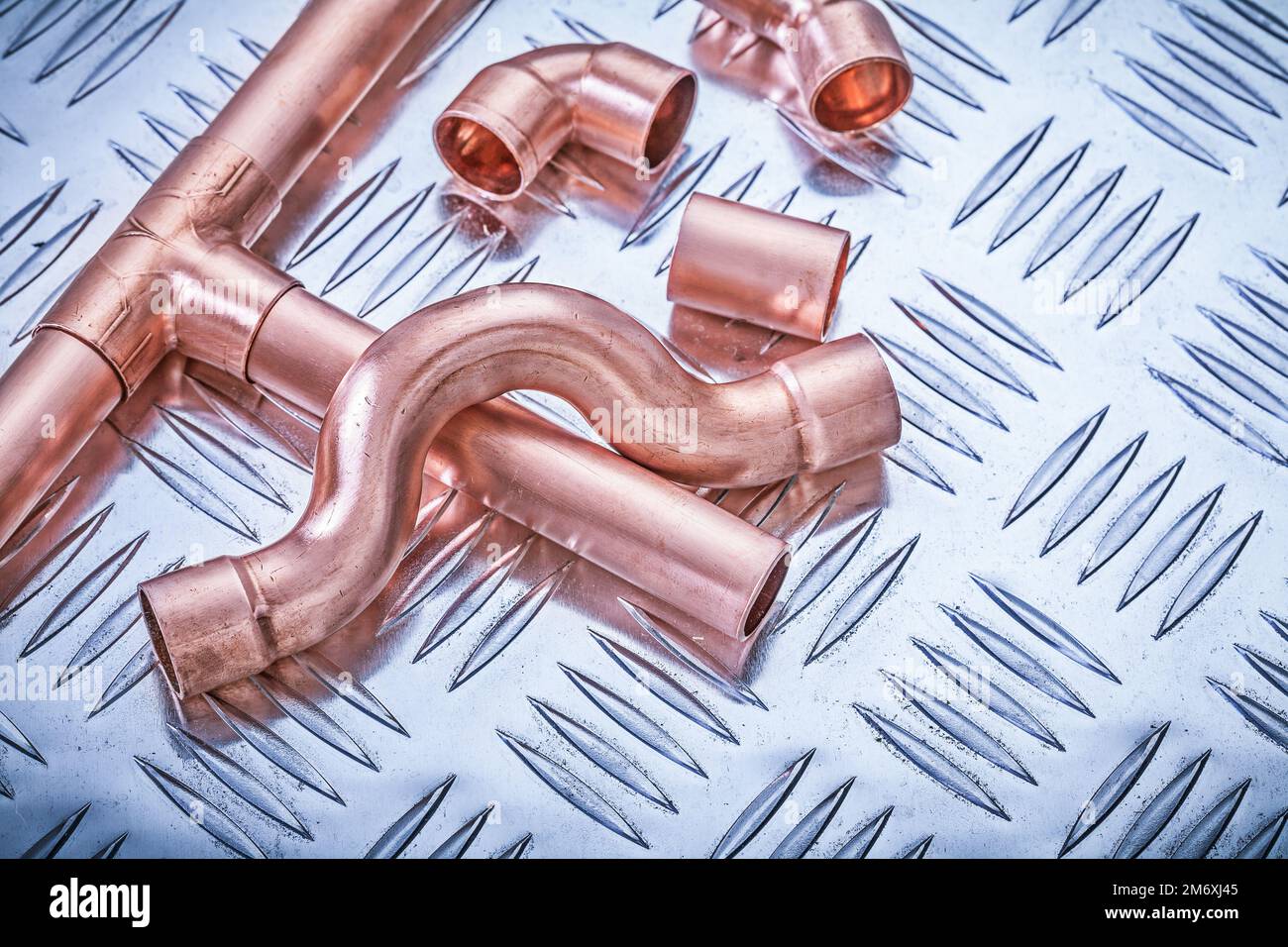Copper pipe fixtures on corrugated metal sheet plumbing concept Stock ...