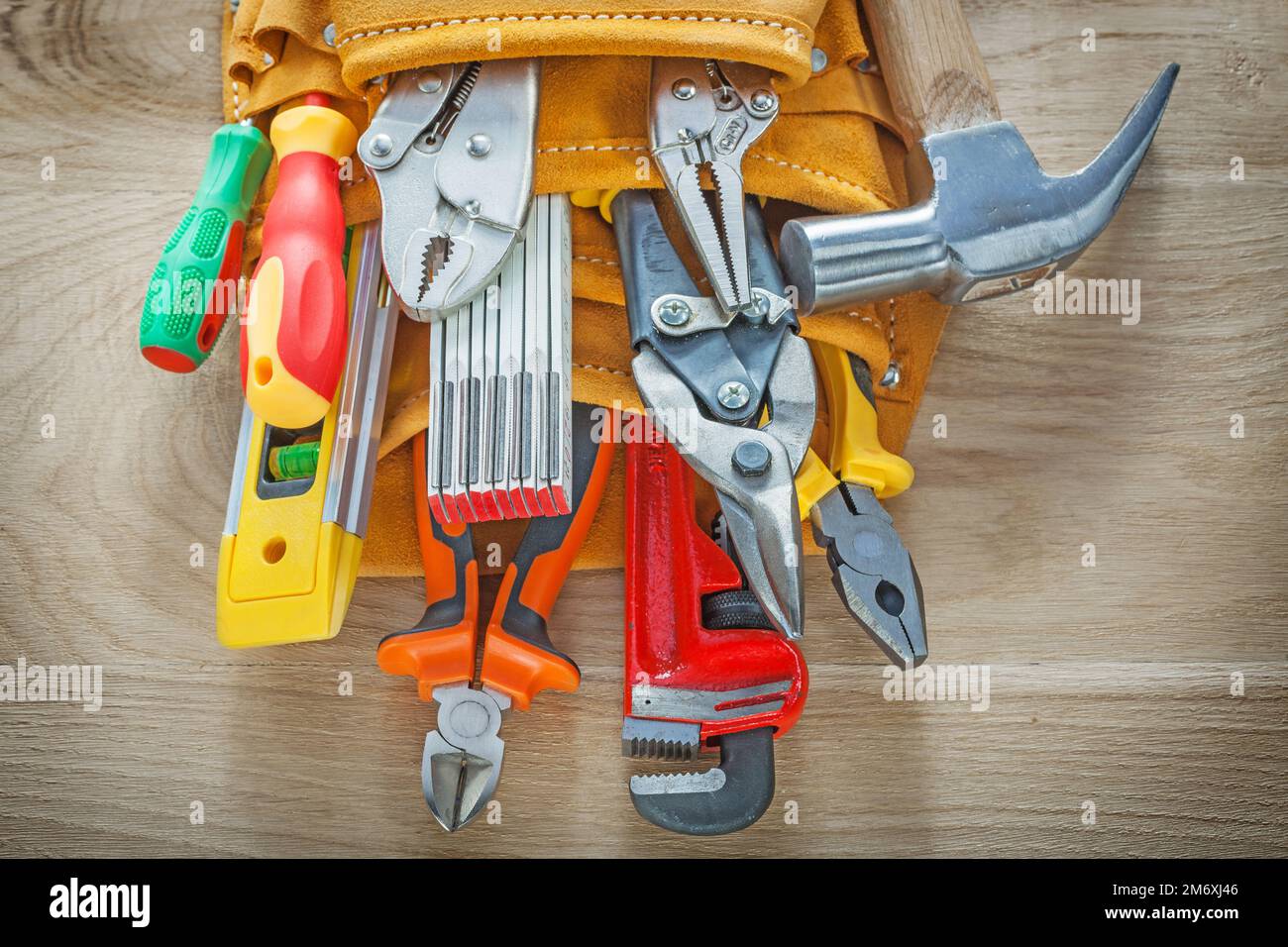 Construction tools in building belt on wood board Stock Photo - Alamy