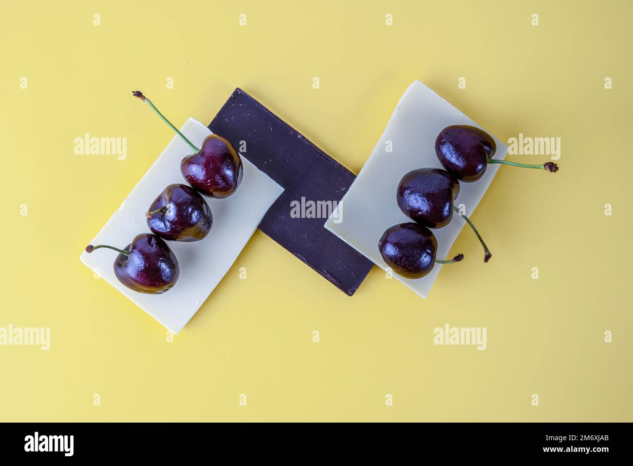 Flat lay of English Morello Cherries on a herringbone pattern white and ...