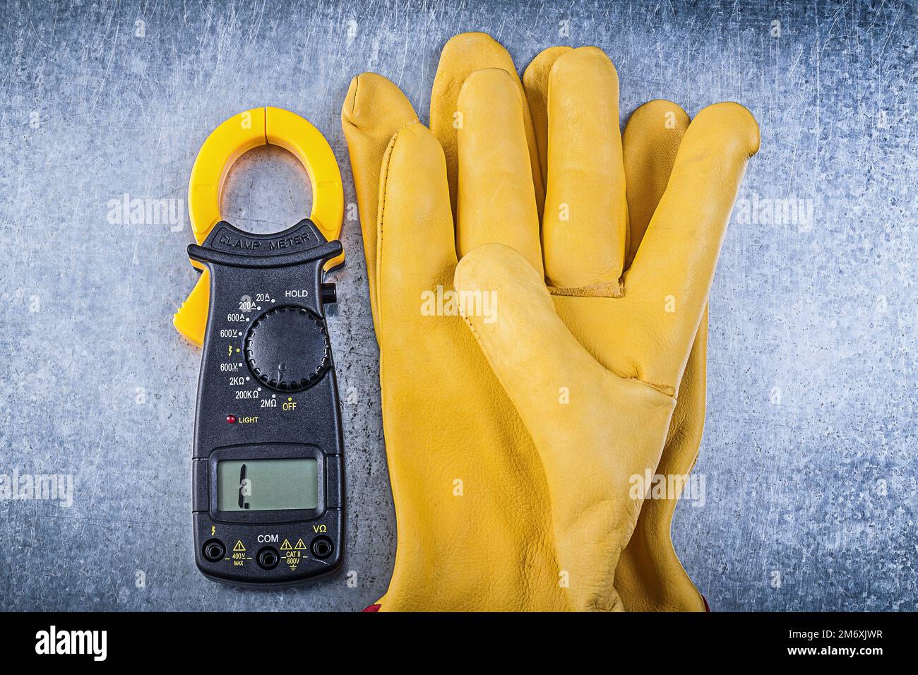 Digital ammeter safety gloves on metallic background Stock Photo - Alamy