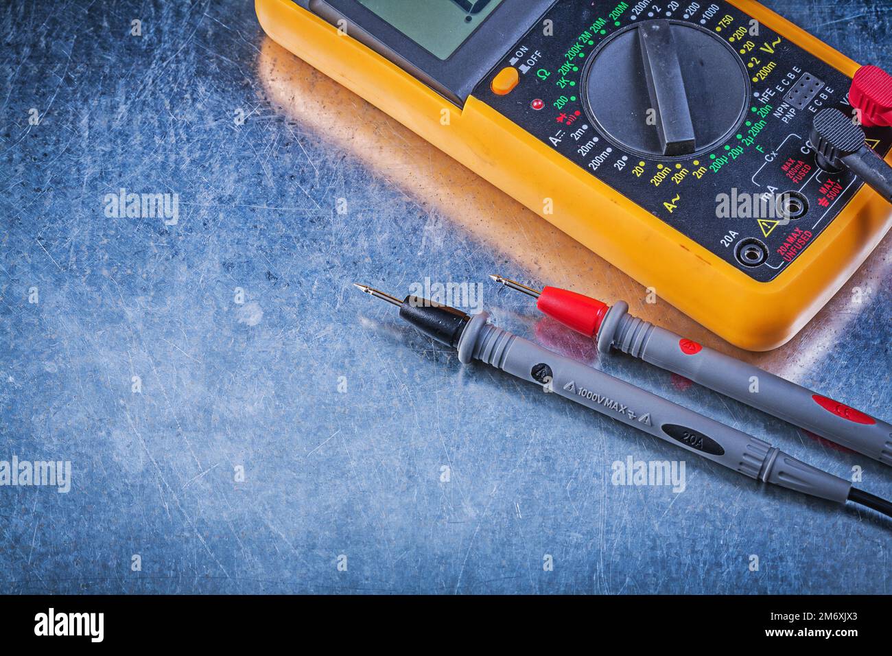 Digital electrical tester on metallic surface close up view electricity ...