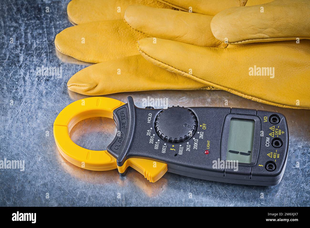 Digital amperemeter protective gloves on metallic background Stock ...