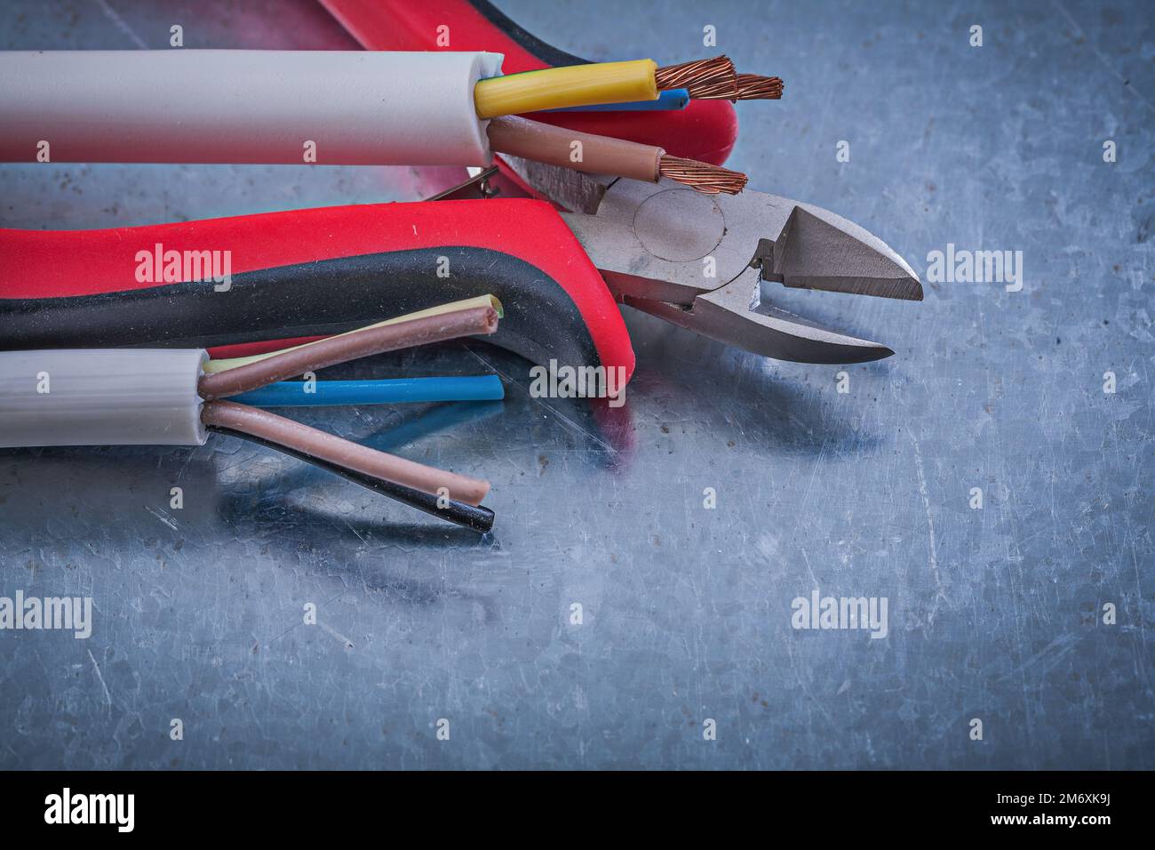 Electric cables wires cutting pliers on metallic background ...