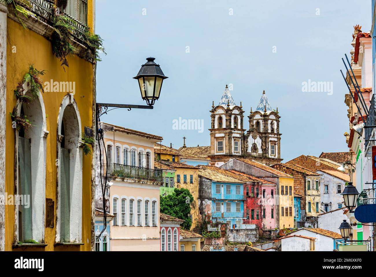 Colorful historical colonial houses and church tower in baroque and ...