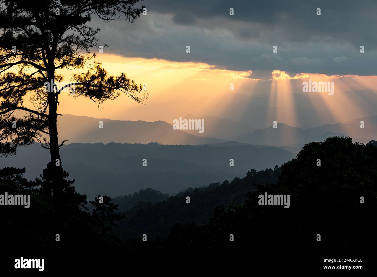 Natural view of dramatic sunset with godlight shining through the ...