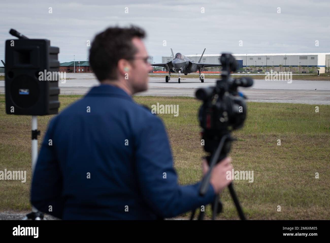 Local news reporters film an F-22 Raptor assigned to the 192nd Fighter ...
