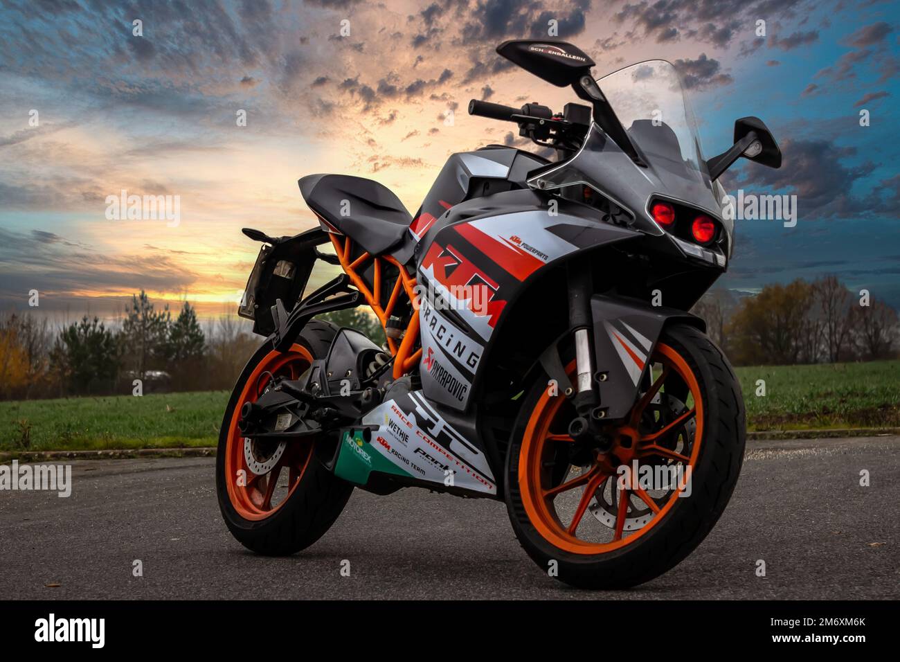 A low angle shot of a parked KTM RC125 Motorcycle on a road under a ...