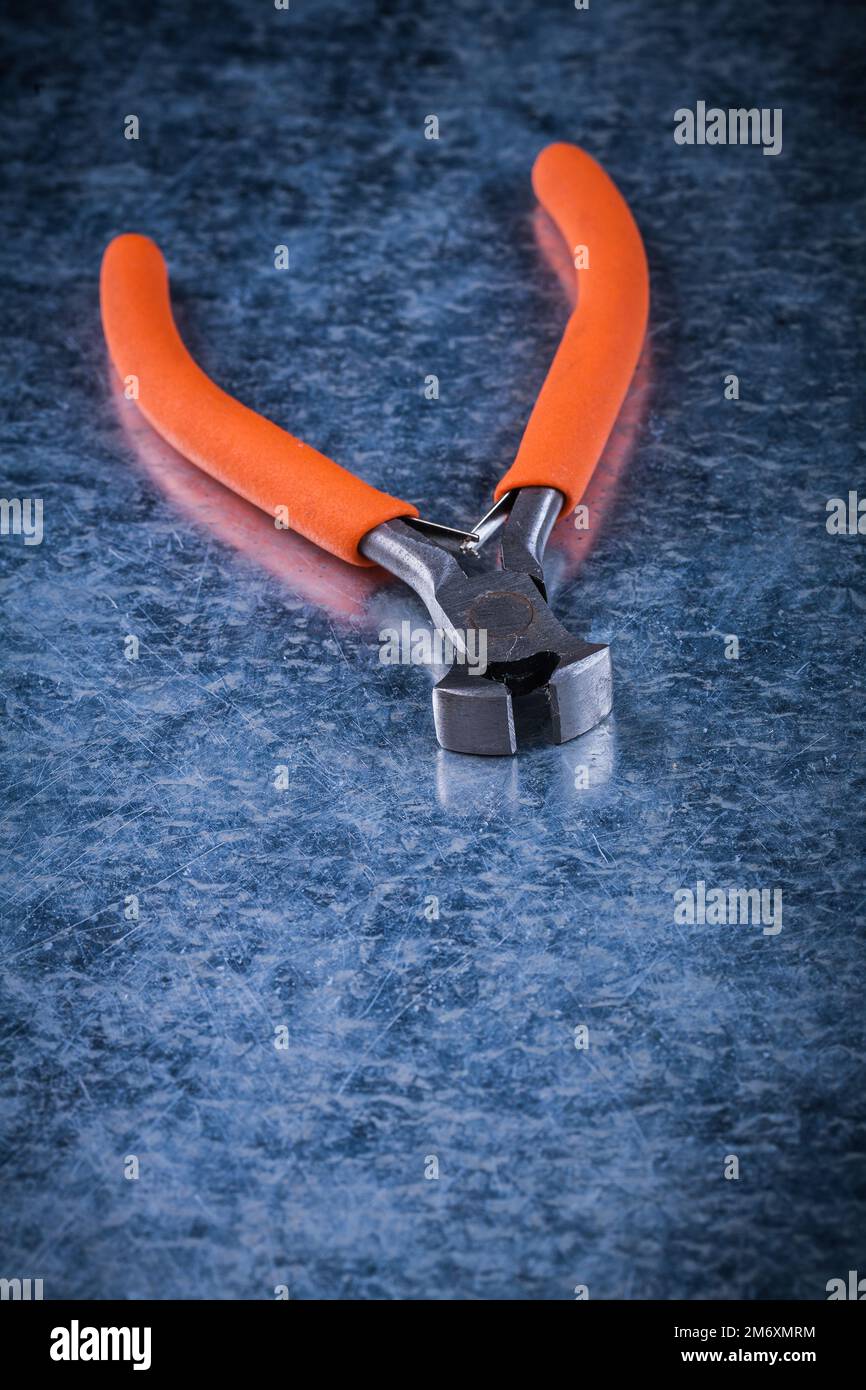 Insulated electric wire cutter on metallic background electricity ...