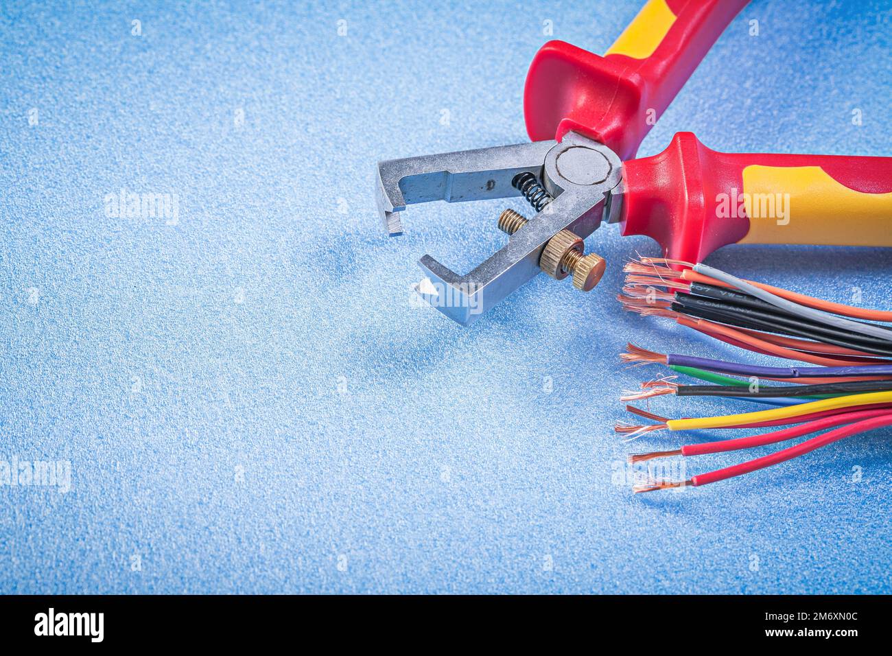 Insulation strippers electrical wires on blue background top view ...