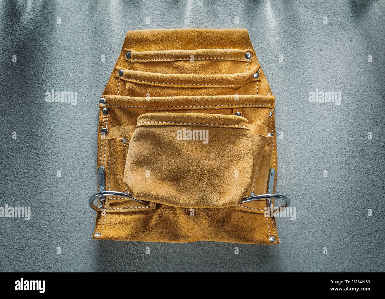 Leather construction belt on concrete background Stock Photo - Alamy